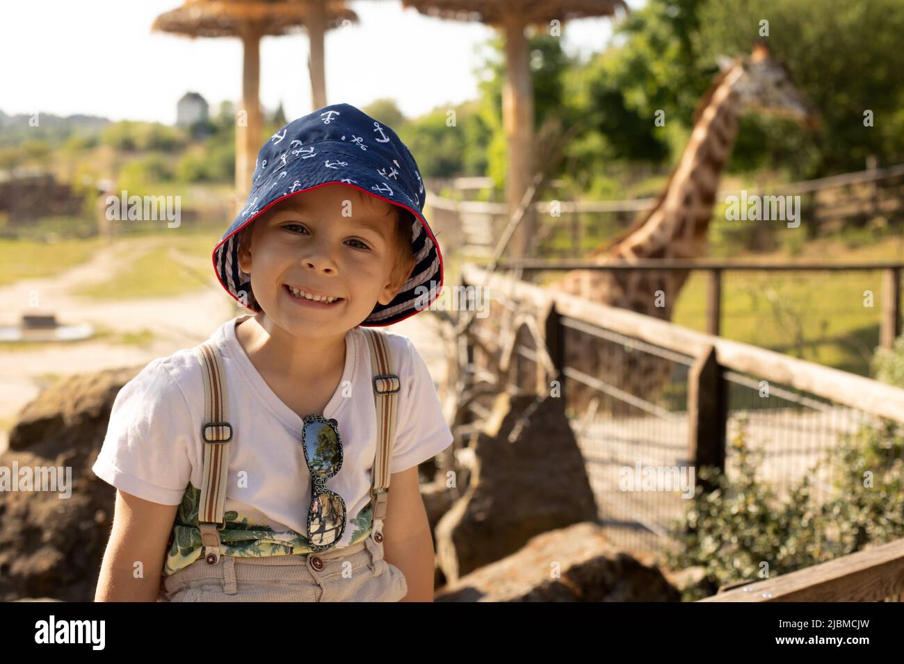 Cute little child, blond boy, walking on sunset in beautiful park ...