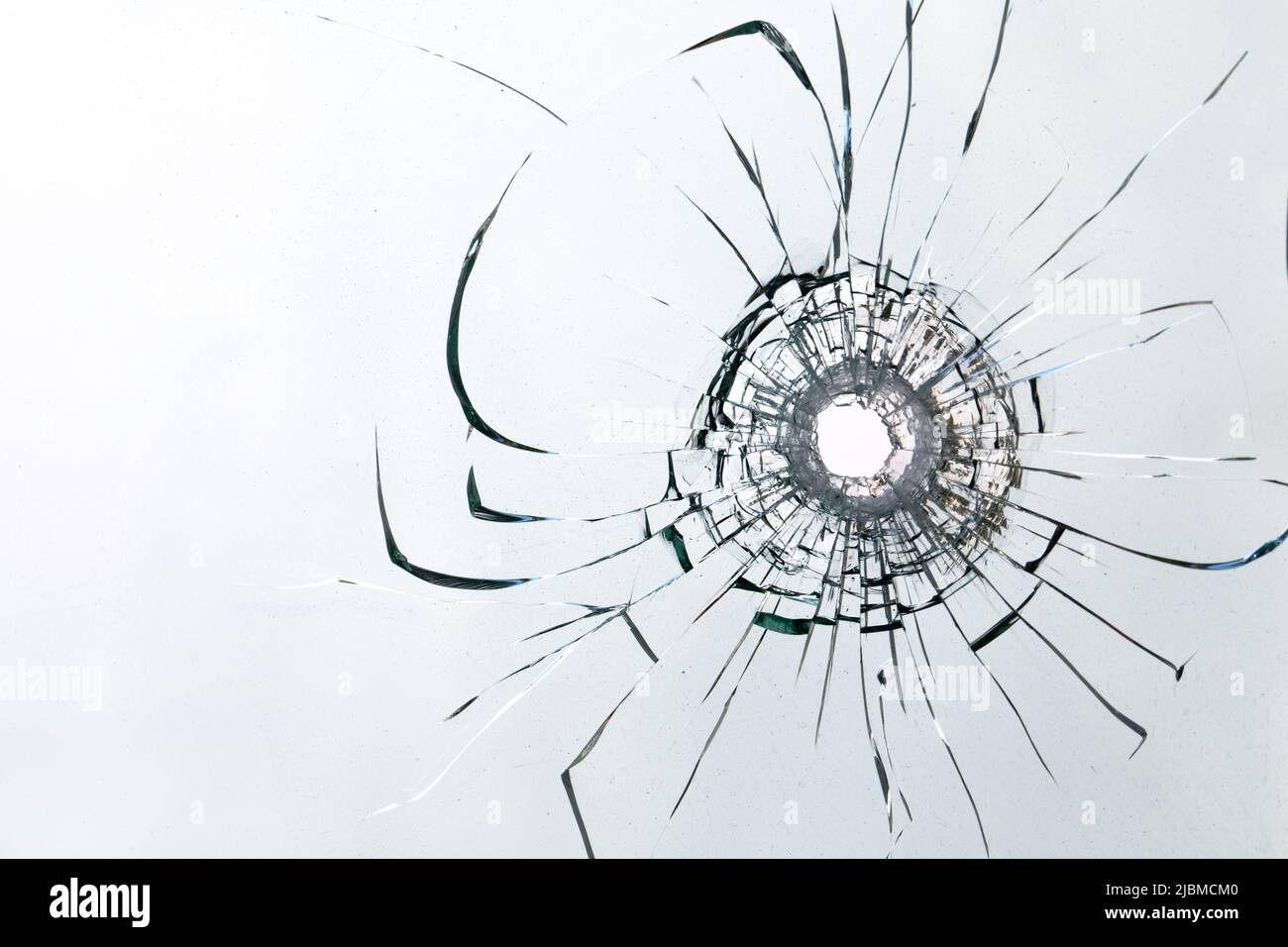 Bullet hole in the rock. Broken window, cracks. Abstract background or ...
