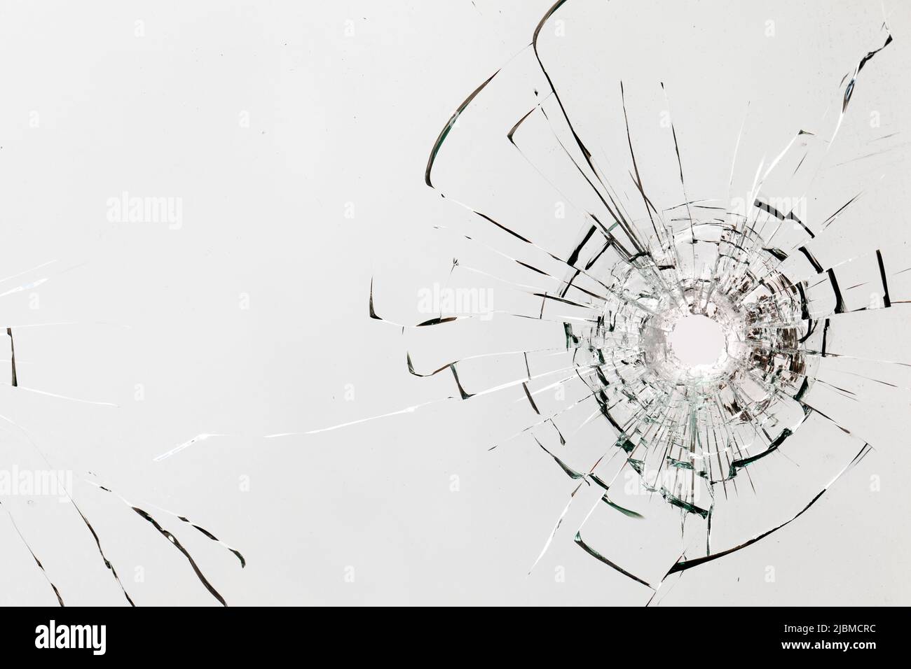 Bullet hole in the rock. Broken window, cracks. Abstract background or ...