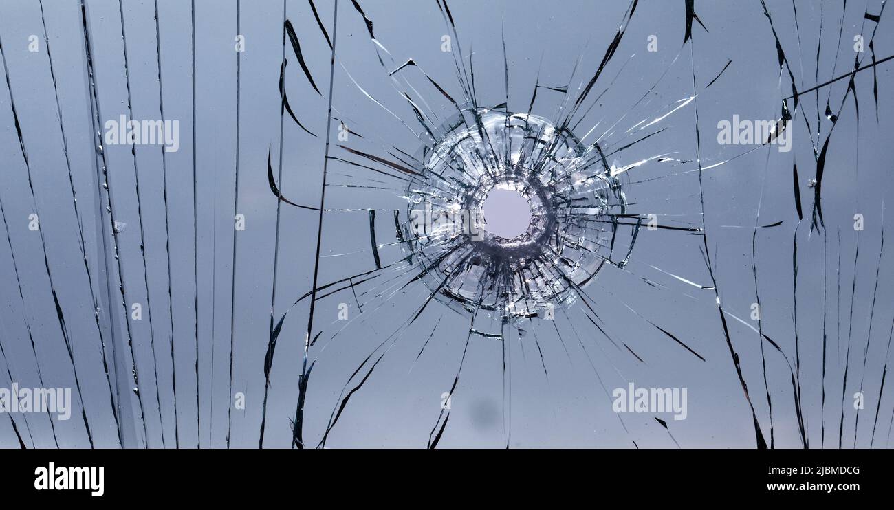 Bullet hole in the rock. Broken window, cracks. Abstract background or ...