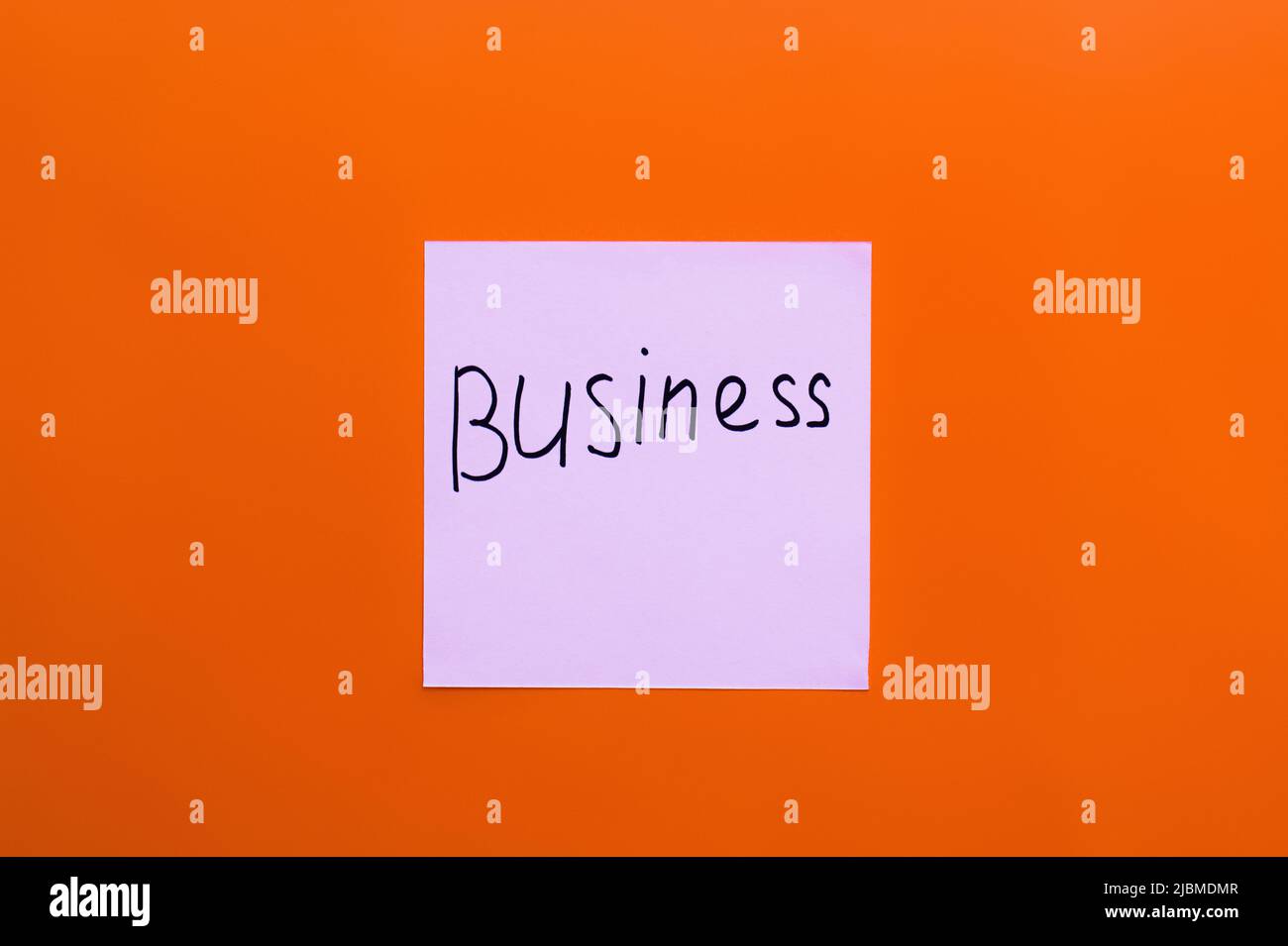 top view of pale violet card with business lettering on red background ...