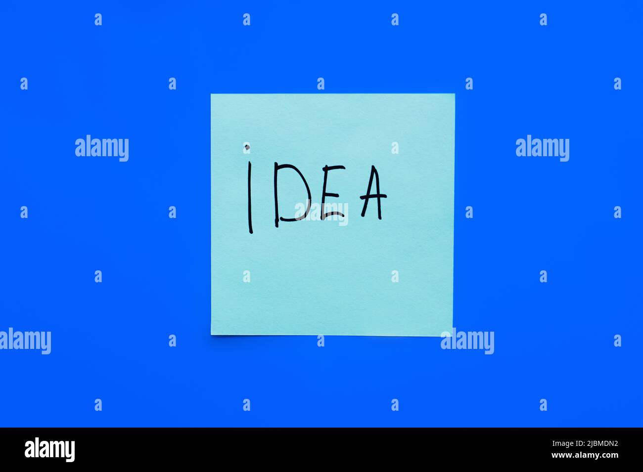 top view of light purple card with idea lettering on blue background ...