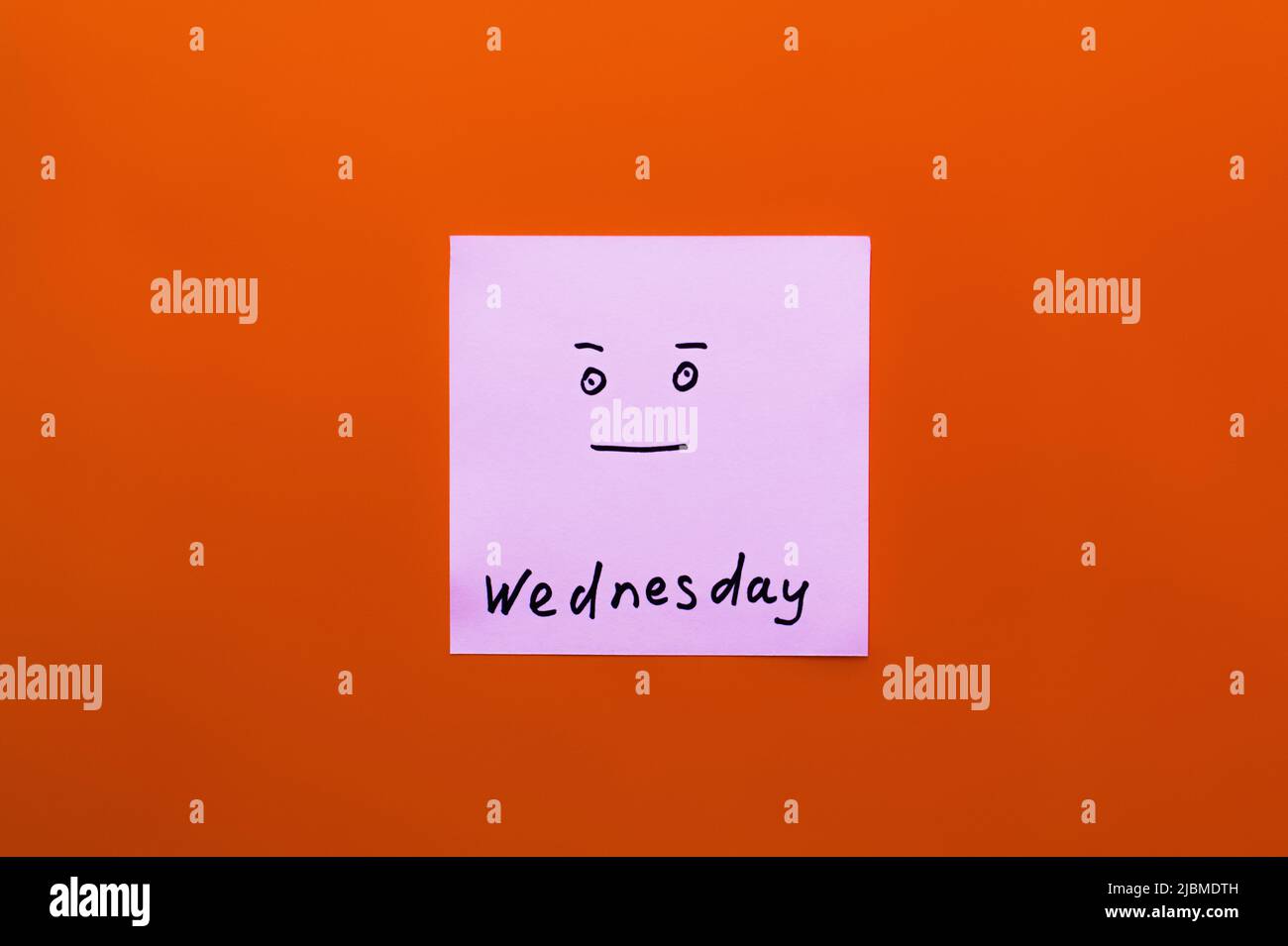 top view of paper note with wednesday lettering and calm smiley on ...