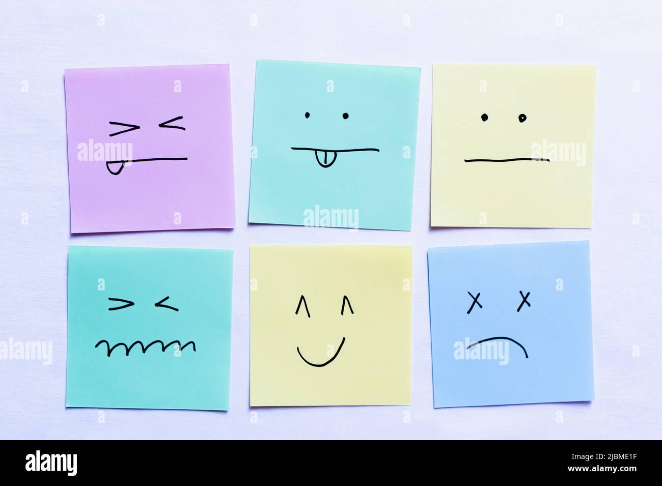 top view of paper cards with various emoticons on white background ...