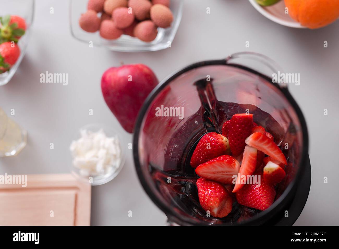 Raw strawberries in blender ready to make fresh homemade smoothie ...