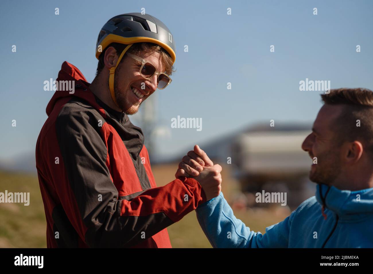 Paragliders high fiving after walking up hill to paragliding starting ...