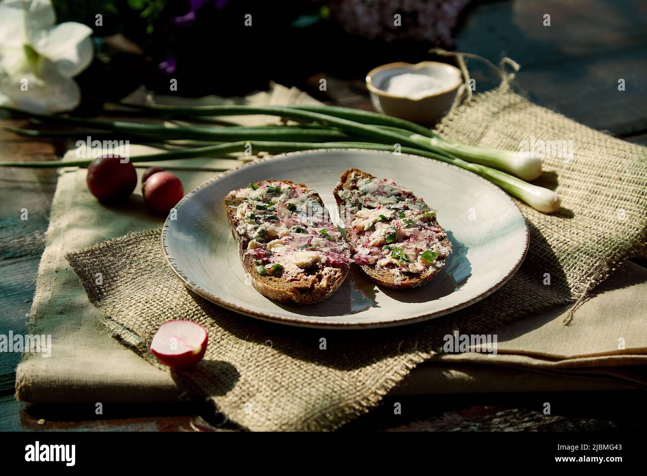 Healthy snack - organic radish smearing on sourdough bread with young ...
