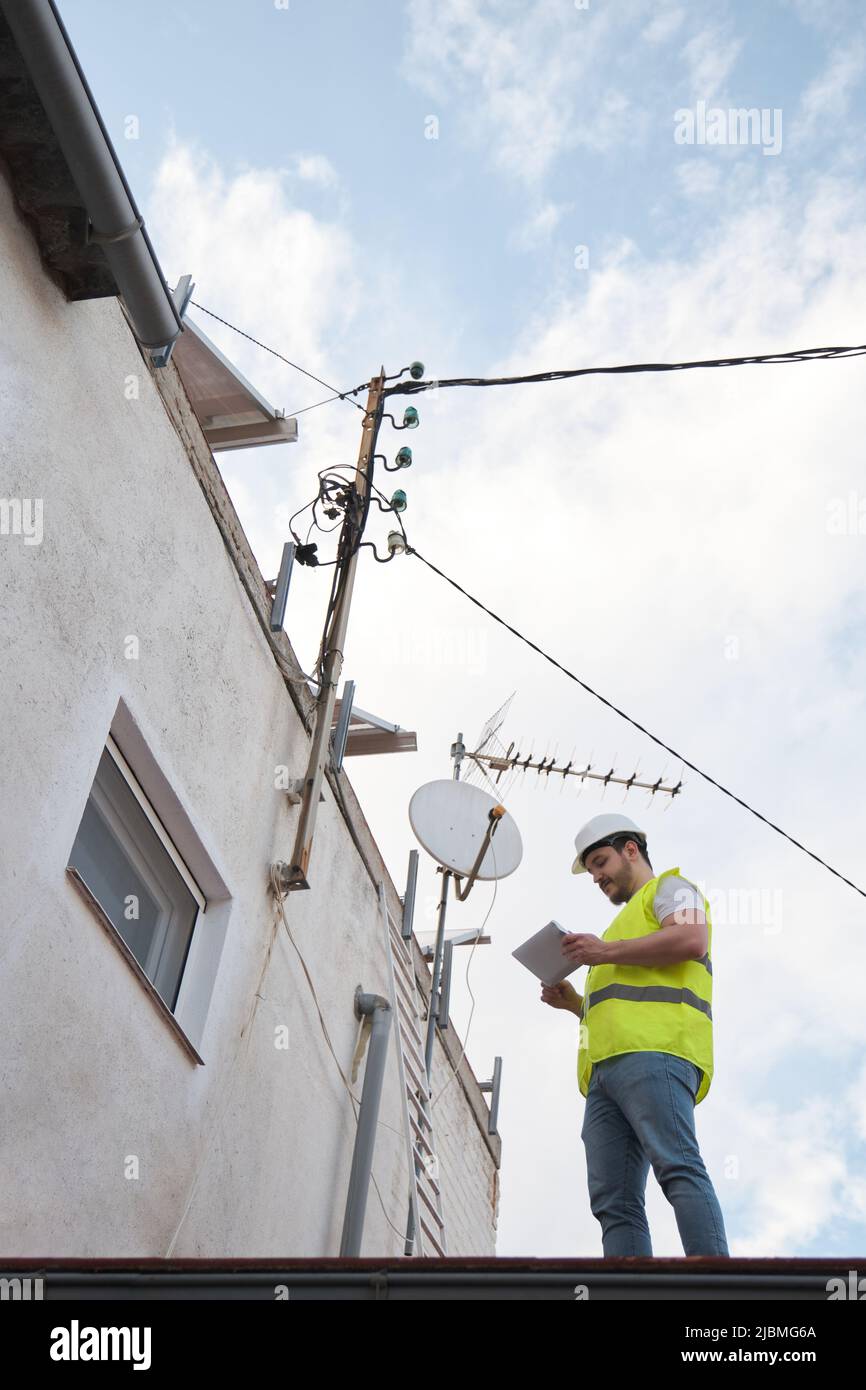 Technician checking electric wire power lines and telephone pole Stock ...