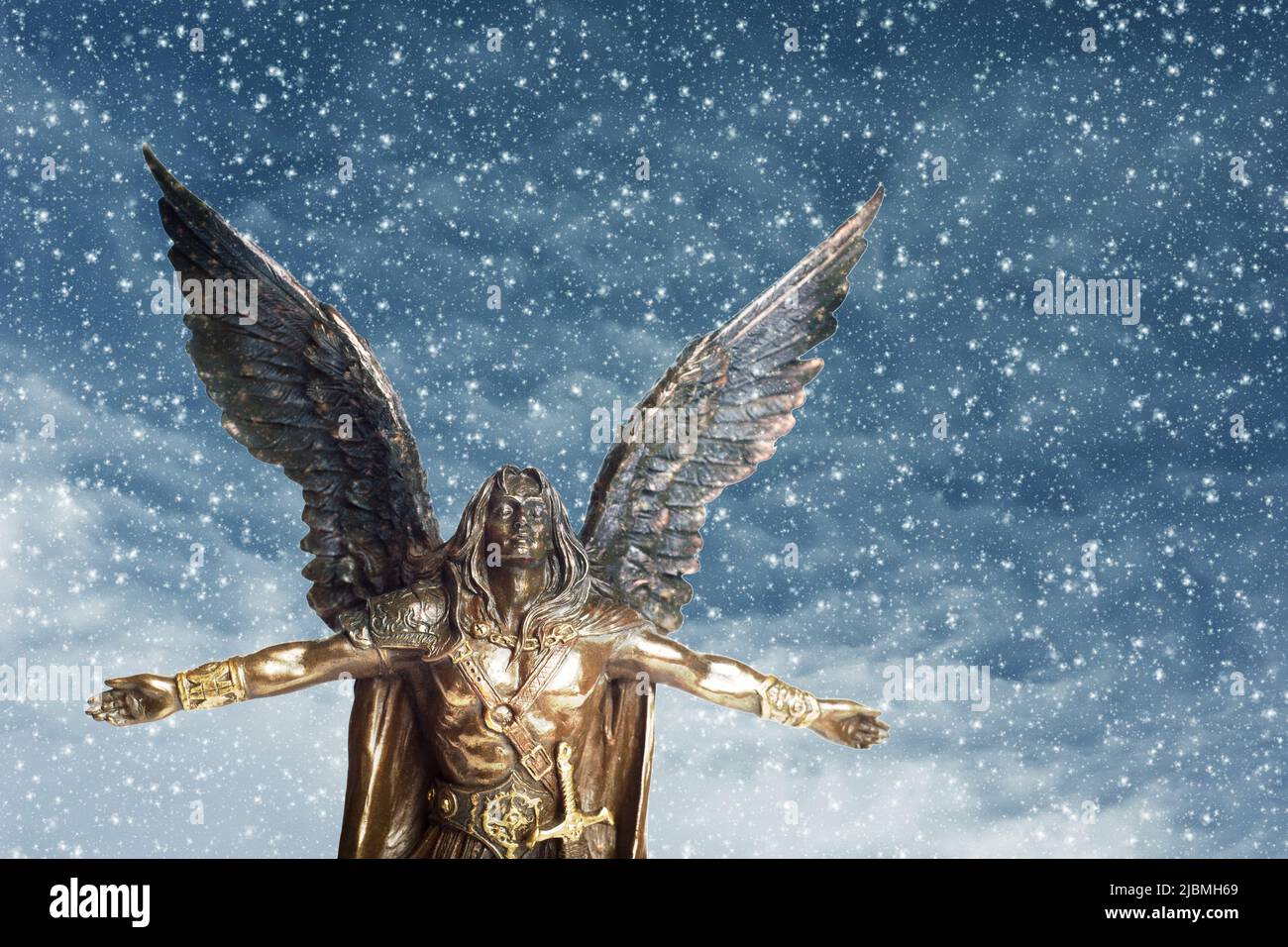 angel statue with open arms and snow falling Stock Photo - Alamy