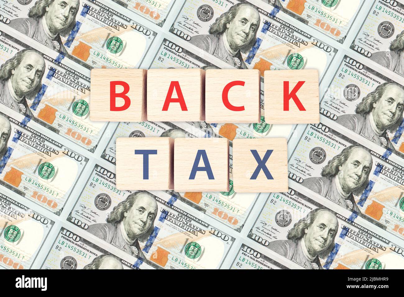 Back taxes concept. Tax cubes on us dollar banknotes background Stock ...