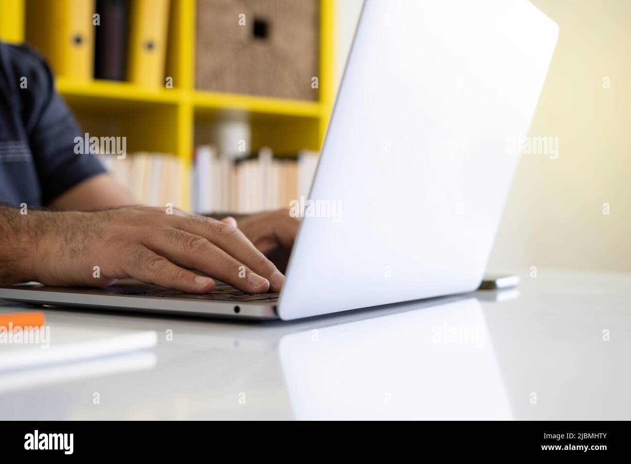 Using laptop, close up image of male hands using laptop. Hands typing ...
