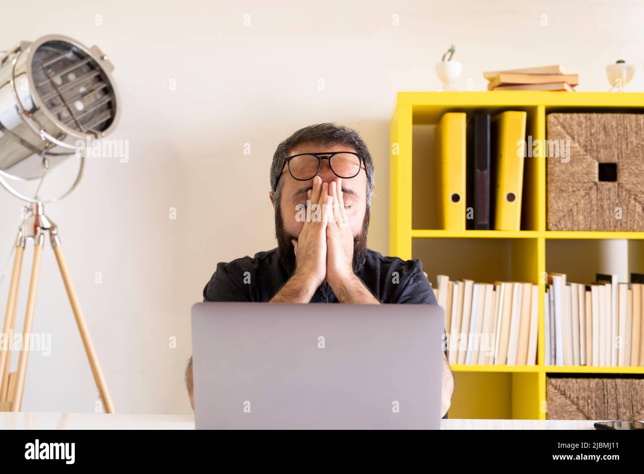 Tired businessman, young tired businessman rubbing his eyes. Confused ...