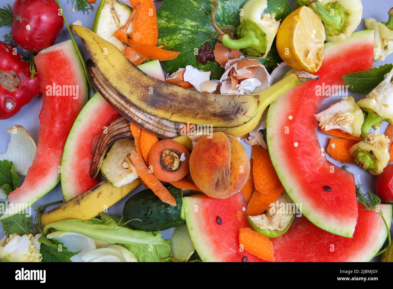 Household waste for composting from fruits and vegetables on a gray ...