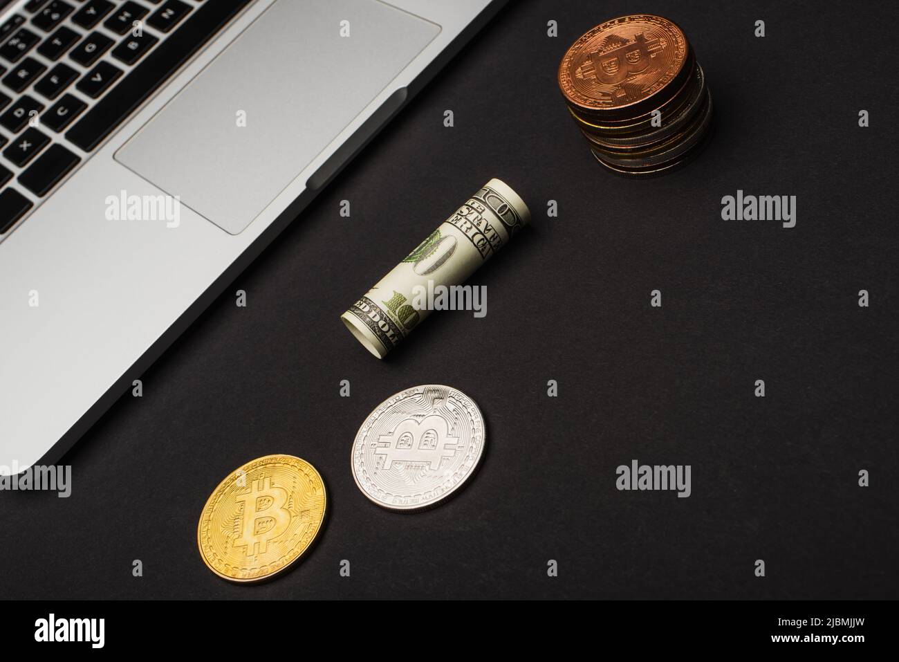 KYIV, UKRAINE - APRIL 26, 2022: Top view of dollar near bitcoins and ...