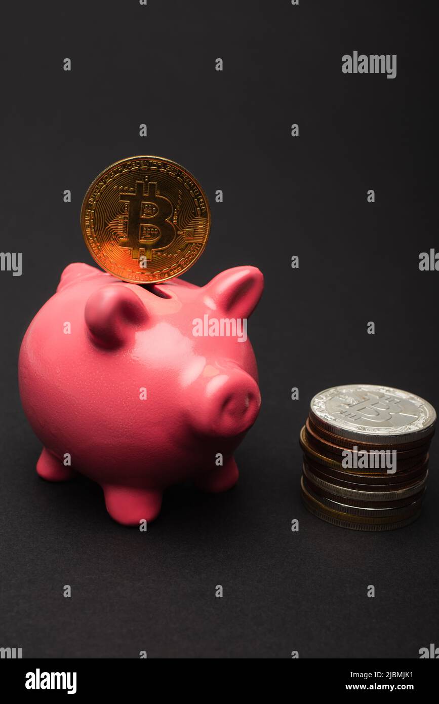 KYIV, UKRAINE - APRIL 26, 2022: Close up view of bitcoin on piggy bank ...