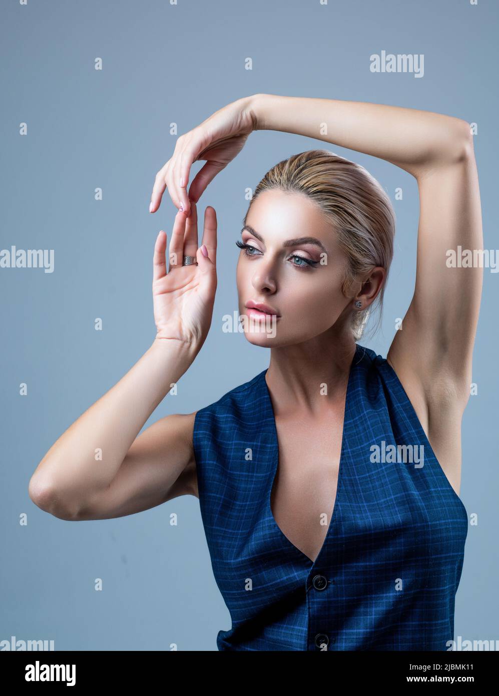 Pretty woman holding arms up showing smooth armpits. Armpit hair ...