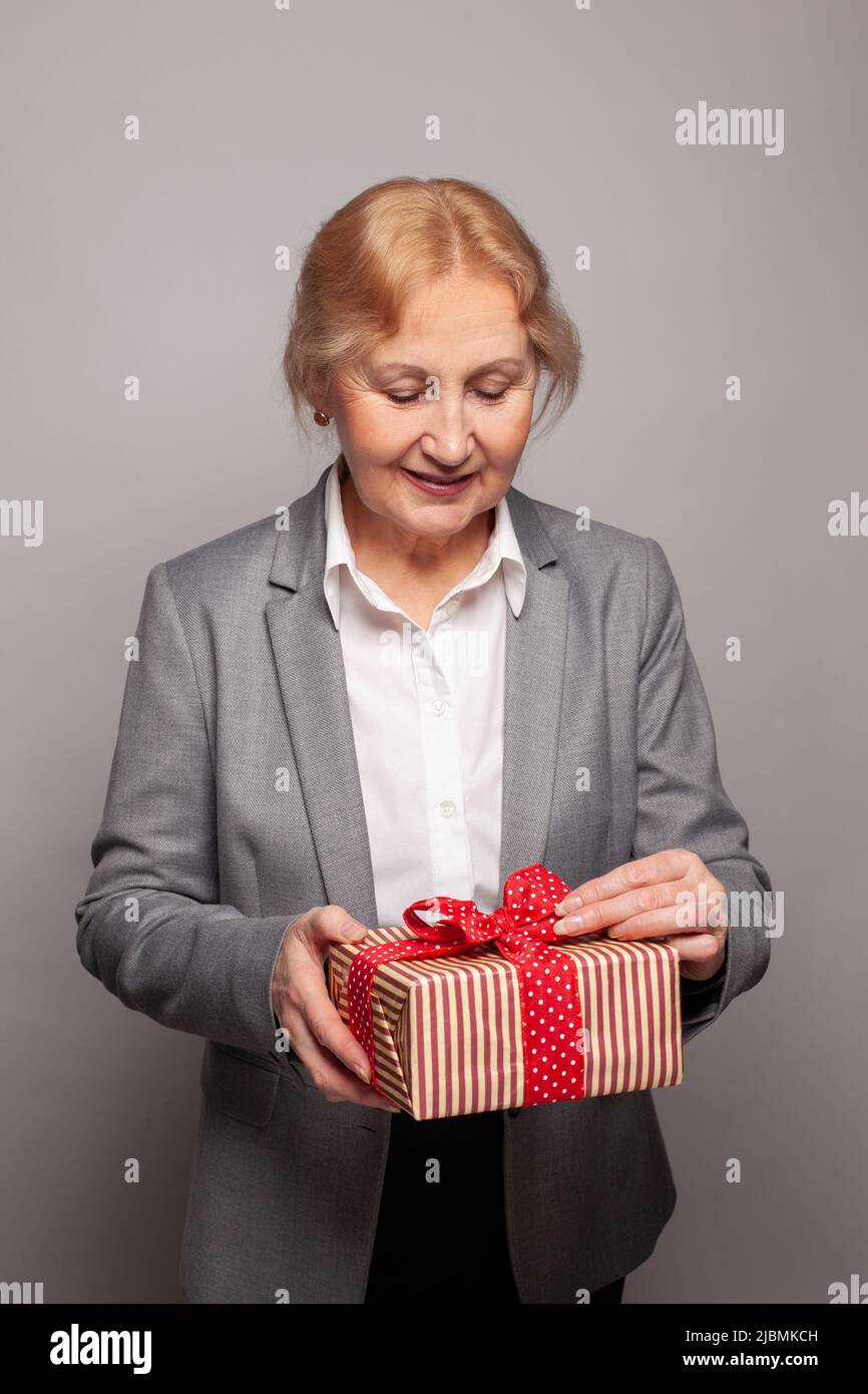 Senior woman opening gift box hi-res stock photography and images - Alamy