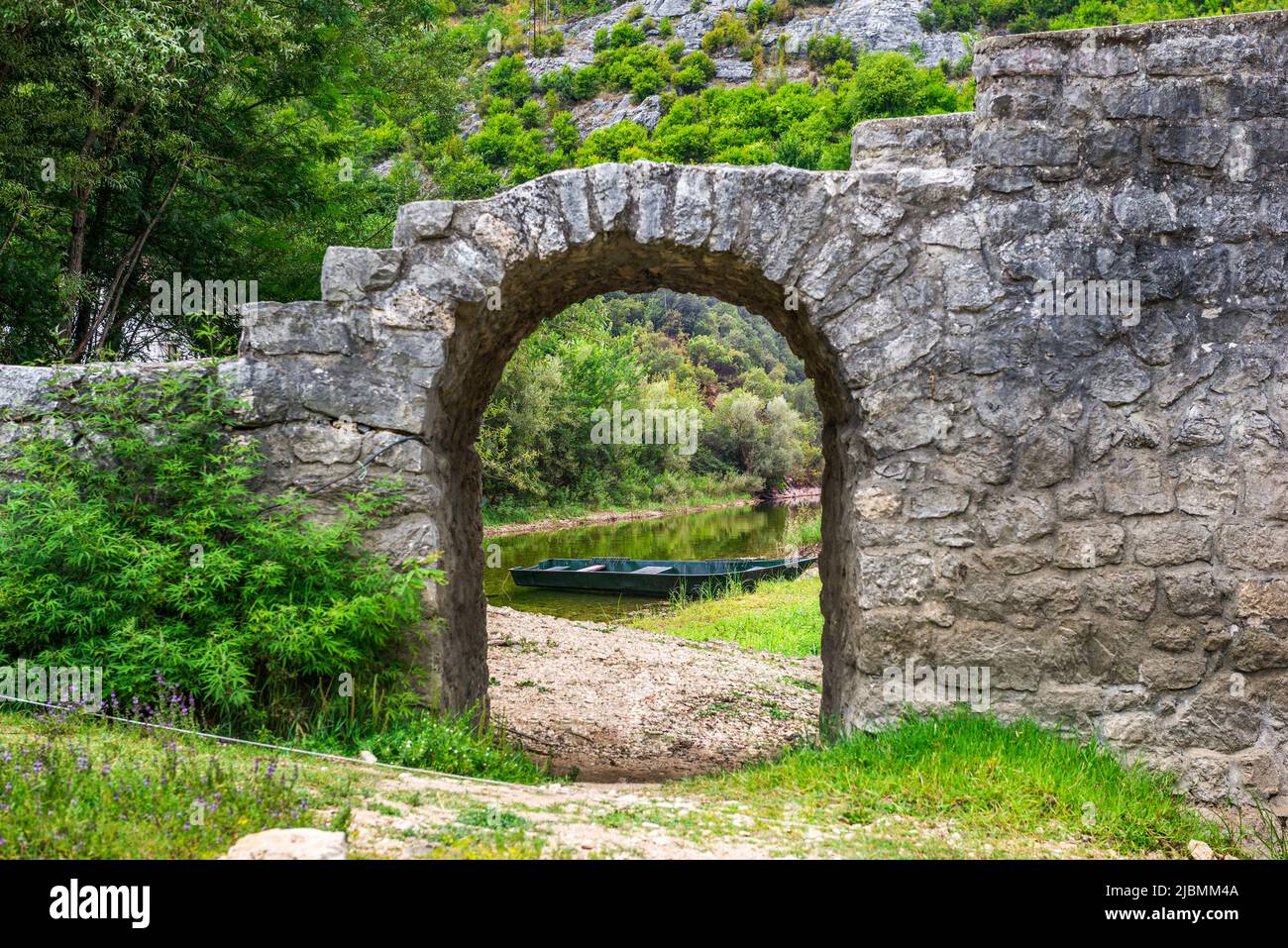 Boat in arch of Stari Most, Montenegro Stock Photo - Alamy