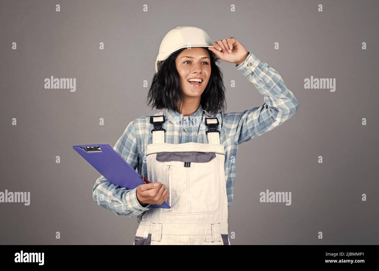 Create your dream home. mechanic girl in hardhat. building and ...