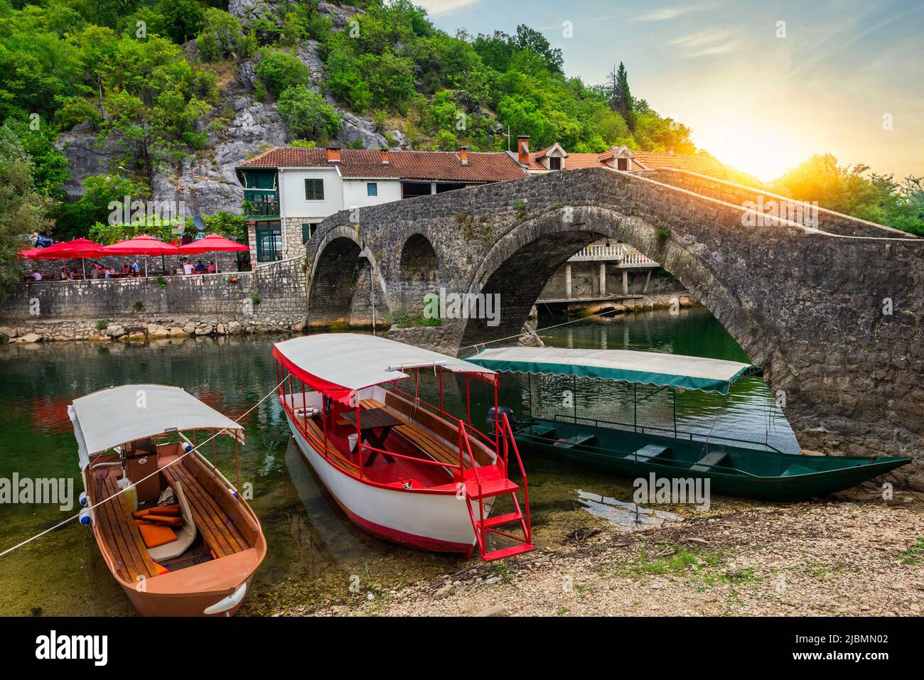 Sunset over Stari Most and boats on Crnojevica river in Montenegro ...