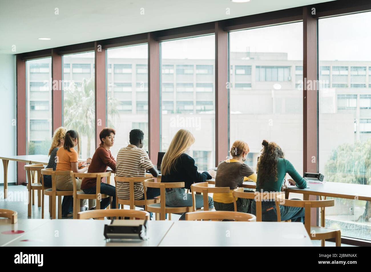 Diverse classmates studying near window Stock Photo - Alamy