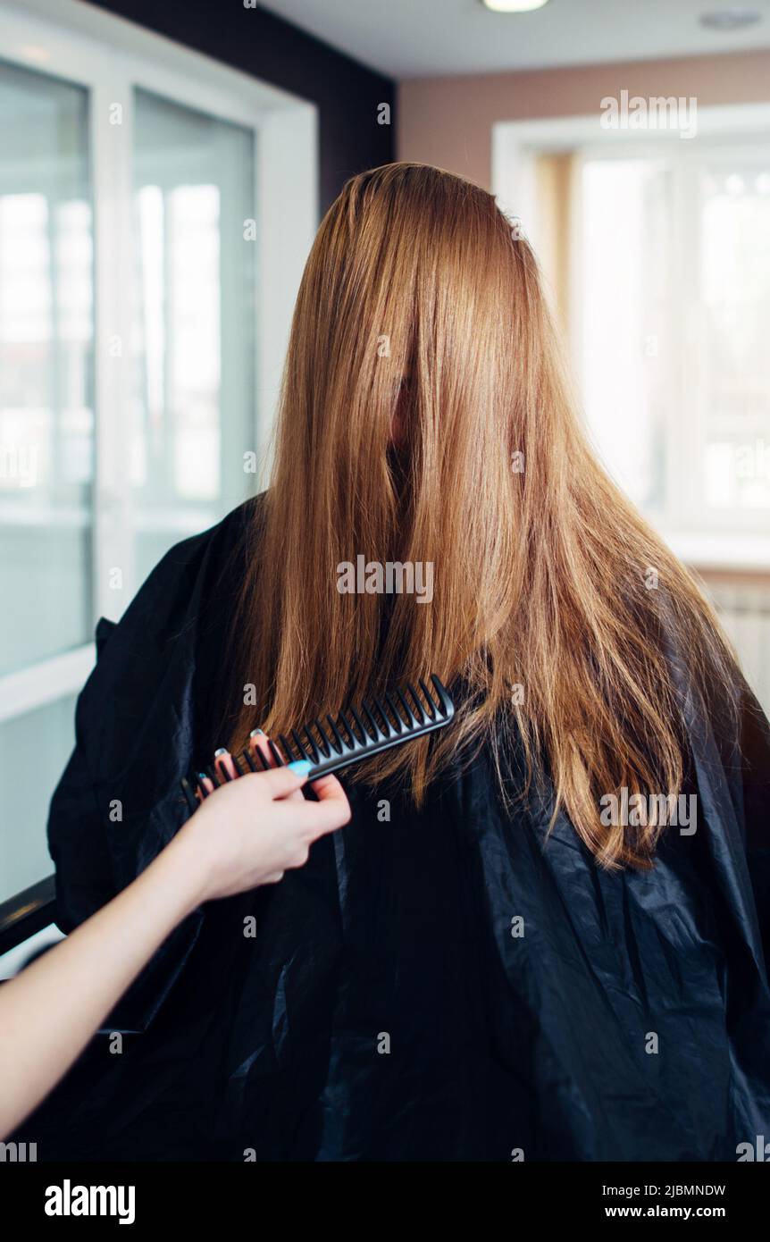 Female customer with long straight fair hair laughing while a ...