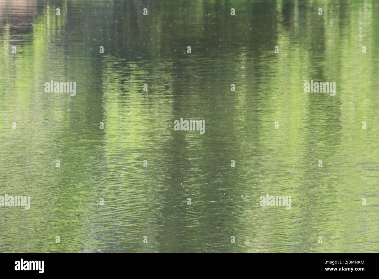 Colours reflected in pond Stock Photo - Alamy