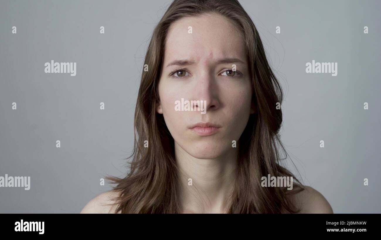 young woman closes nose because of a bad smell Stock Photo - Alamy