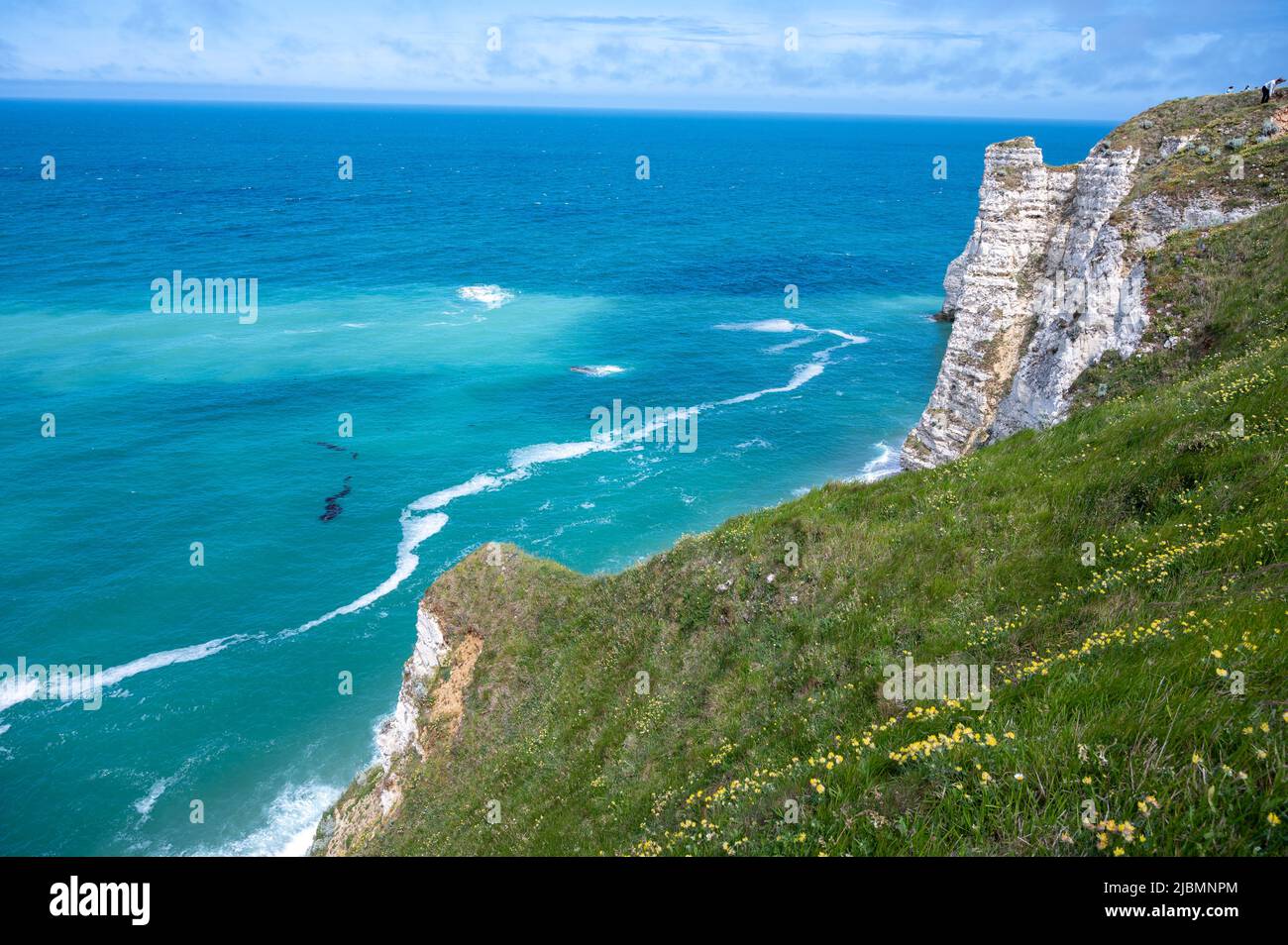 View from chalk cliffs near Porte d'Aval arch in Etretat village on ...