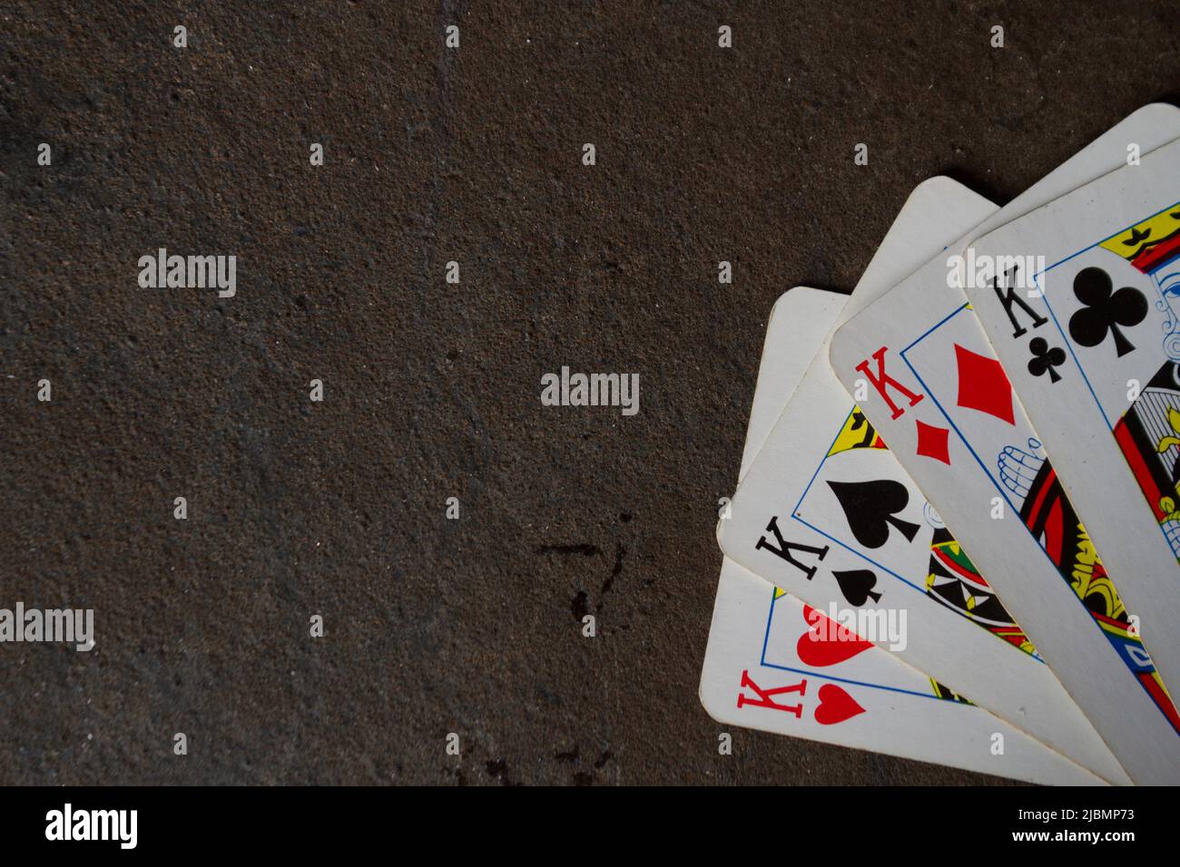 Four kings. Playing cards on black background Stock Photo - Alamy