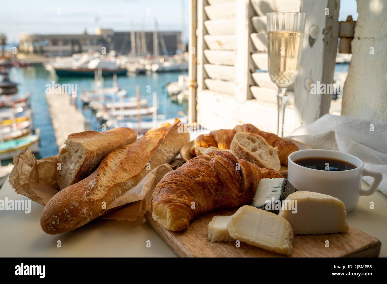 French breakfast with fresh baked croissants, baquett bread, crottin ...