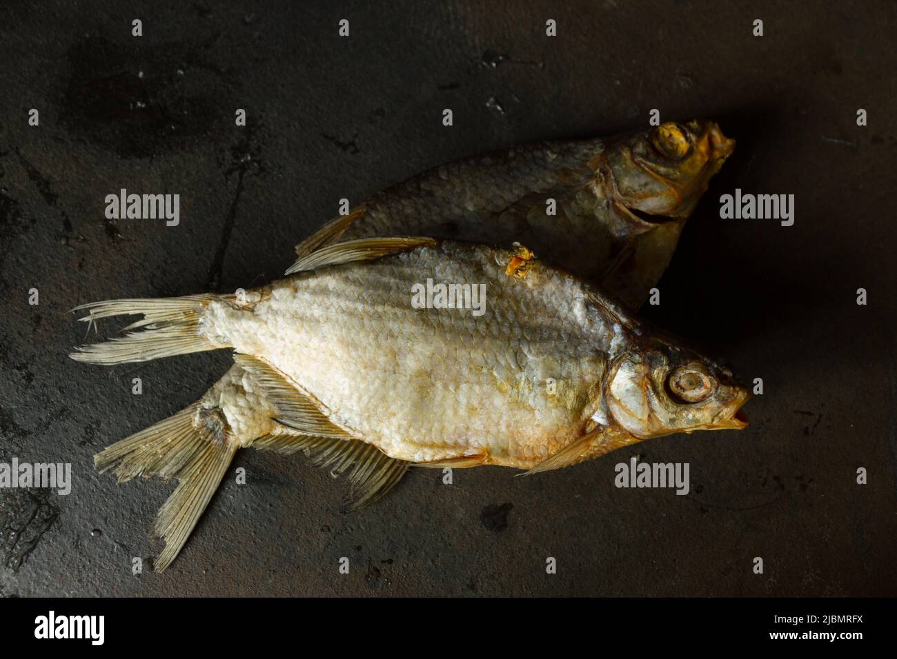 Sun dried fish. Black backround Stock Photo - Alamy