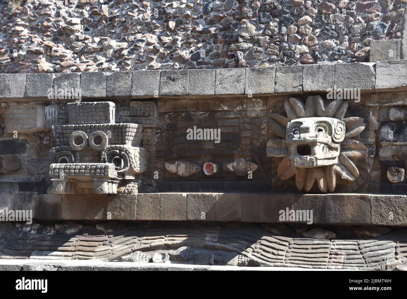 A serpent head and a carving of Tlaloc, the rain god, in Ciudadela, a ...