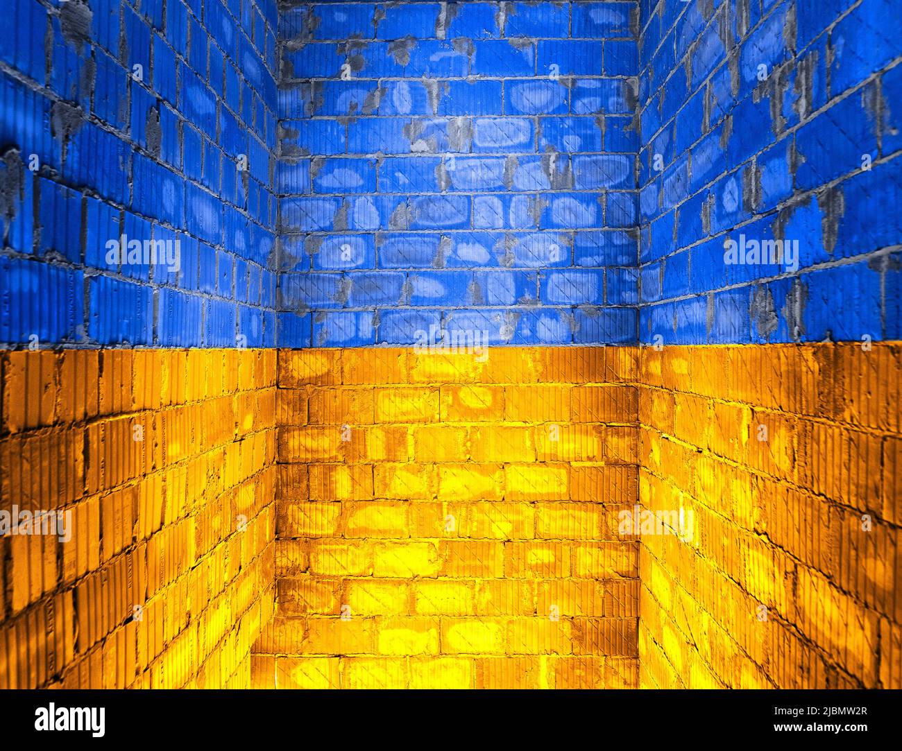 The brick wall is painted in the colors of the Ukrainian flag. Symbol ...