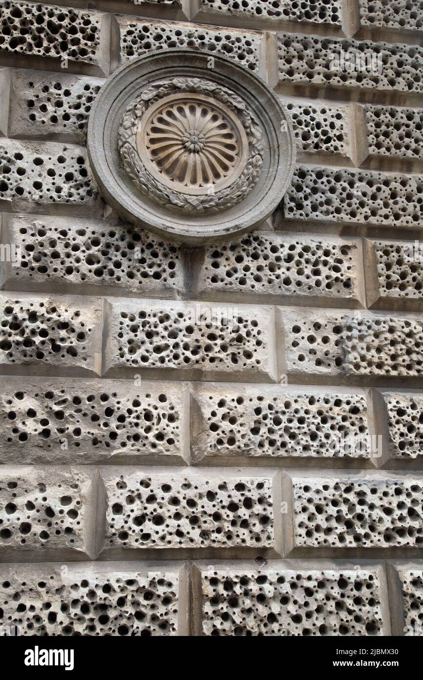 Decorated stone wall with a circular feature, shot close up for use as ...