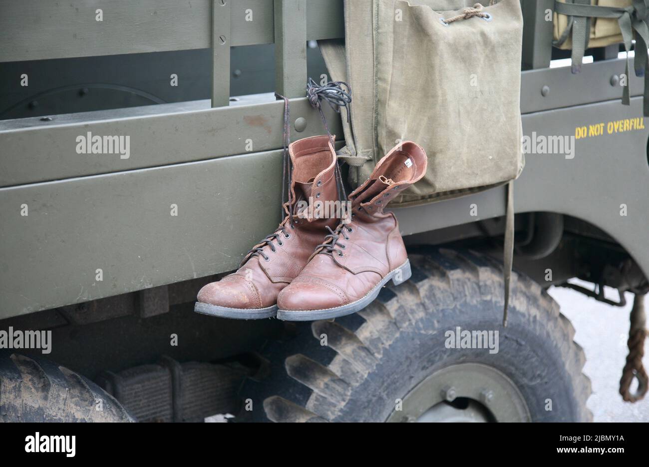 Army boots hanging from a military vehicle Stock Photo - Alamy