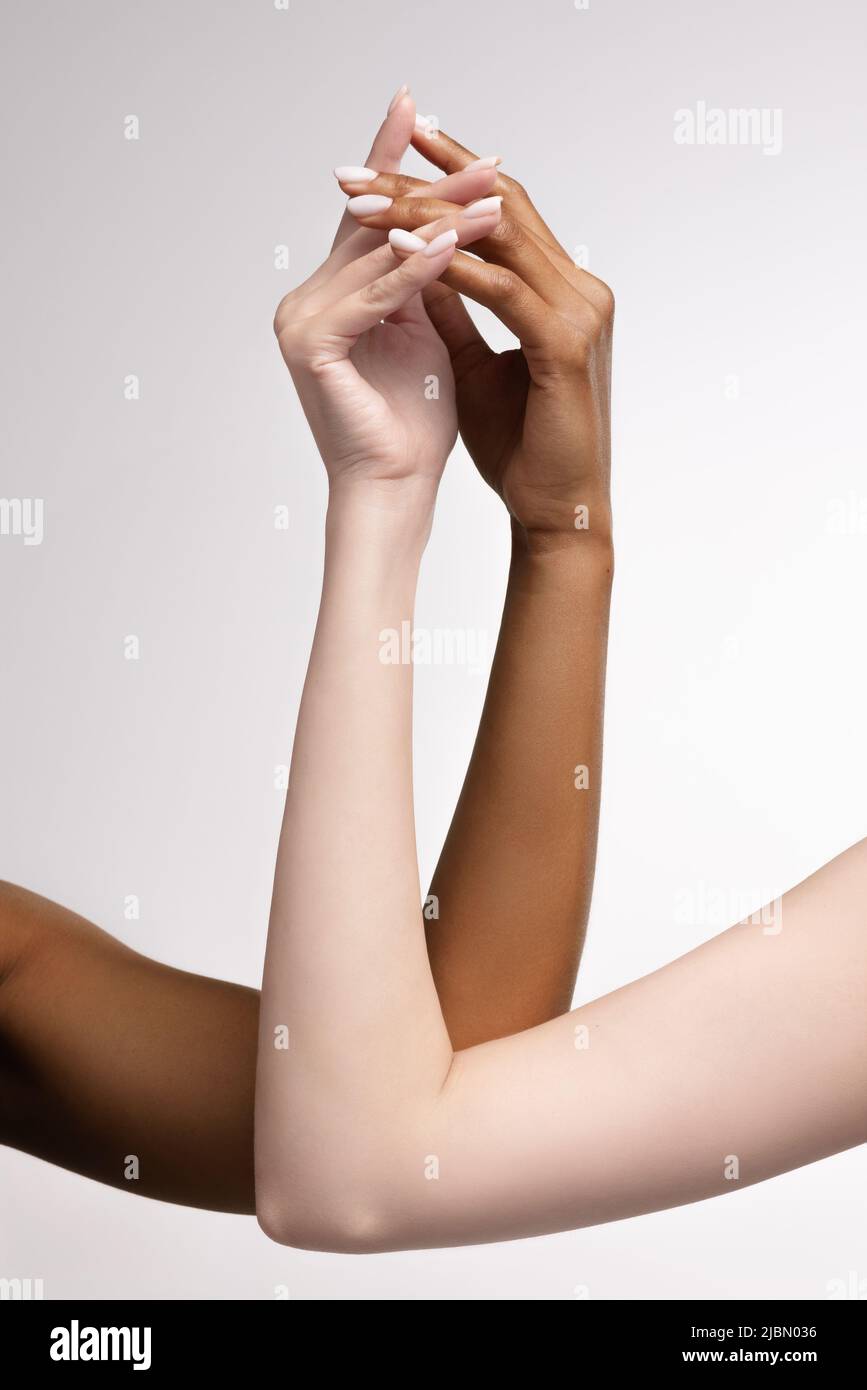 Plexus of female hands. Graceful female hands touch each other isolated ...