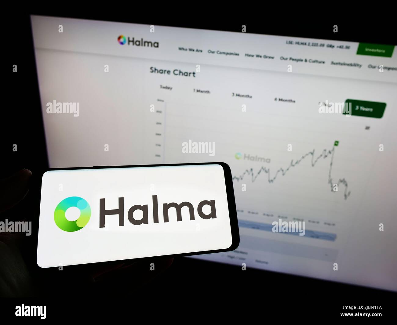 Person holding mobile phone with logo of British safety equipment ...