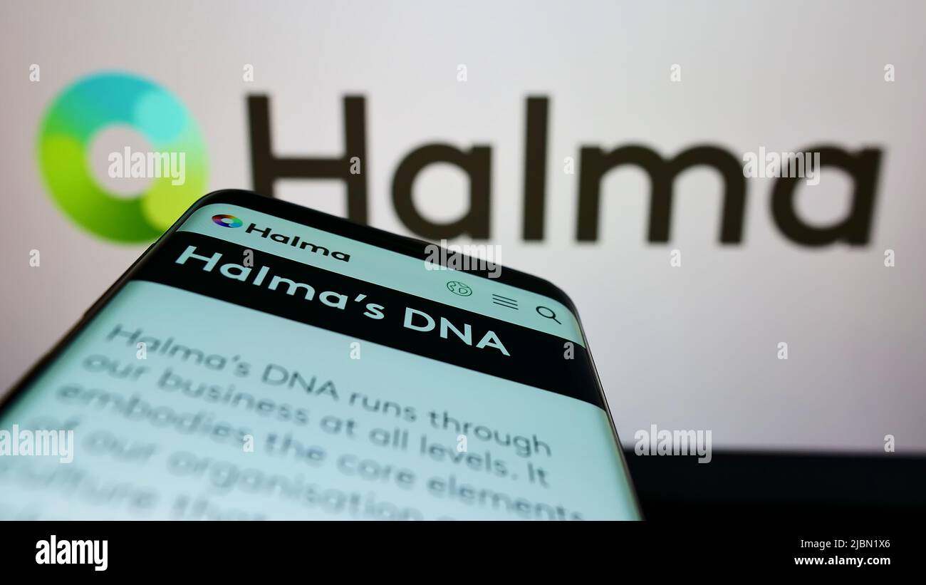Smartphone with website of British safety equipment company Halma plc on screen in front of ...