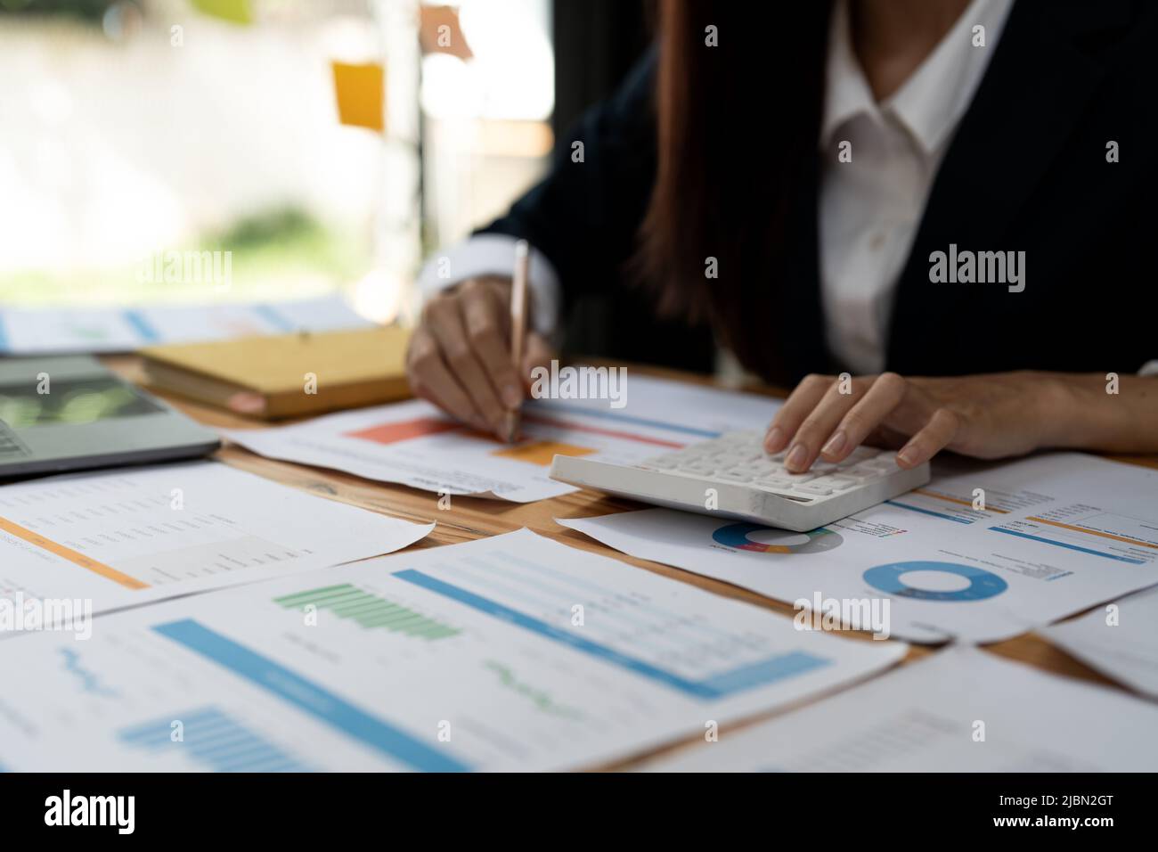 Close up of businessman or accountant hand holding pen working on ...