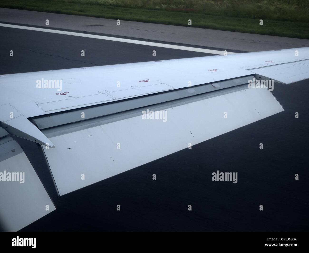 Airplane open flaps while landing detail Stock Photo - Alamy