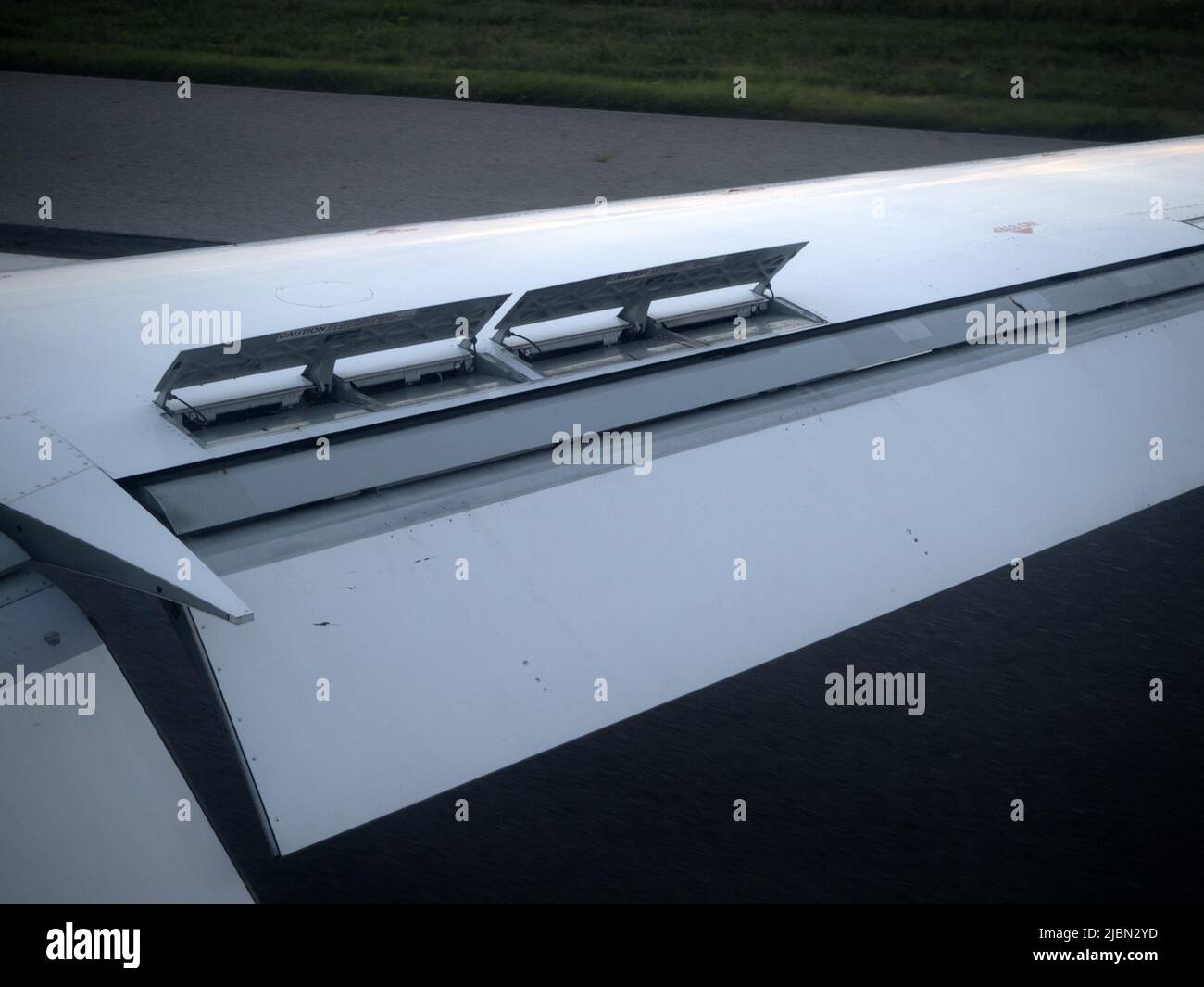 Airplane open flaps while landing detail Stock Photo - Alamy