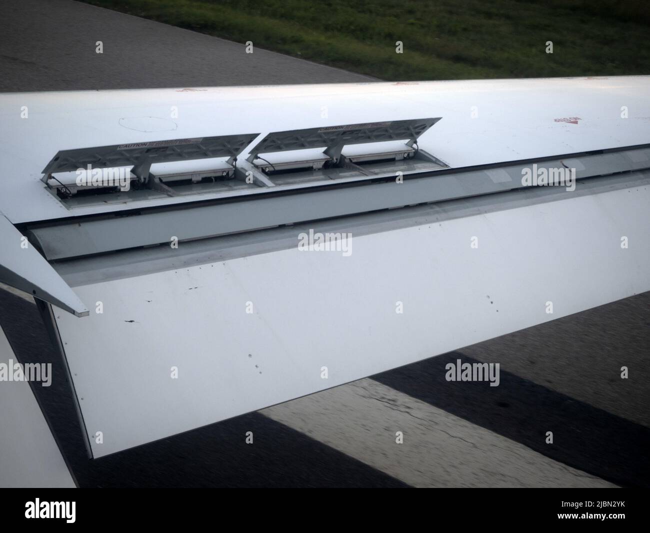 Airplane open flaps while landing detail Stock Photo - Alamy