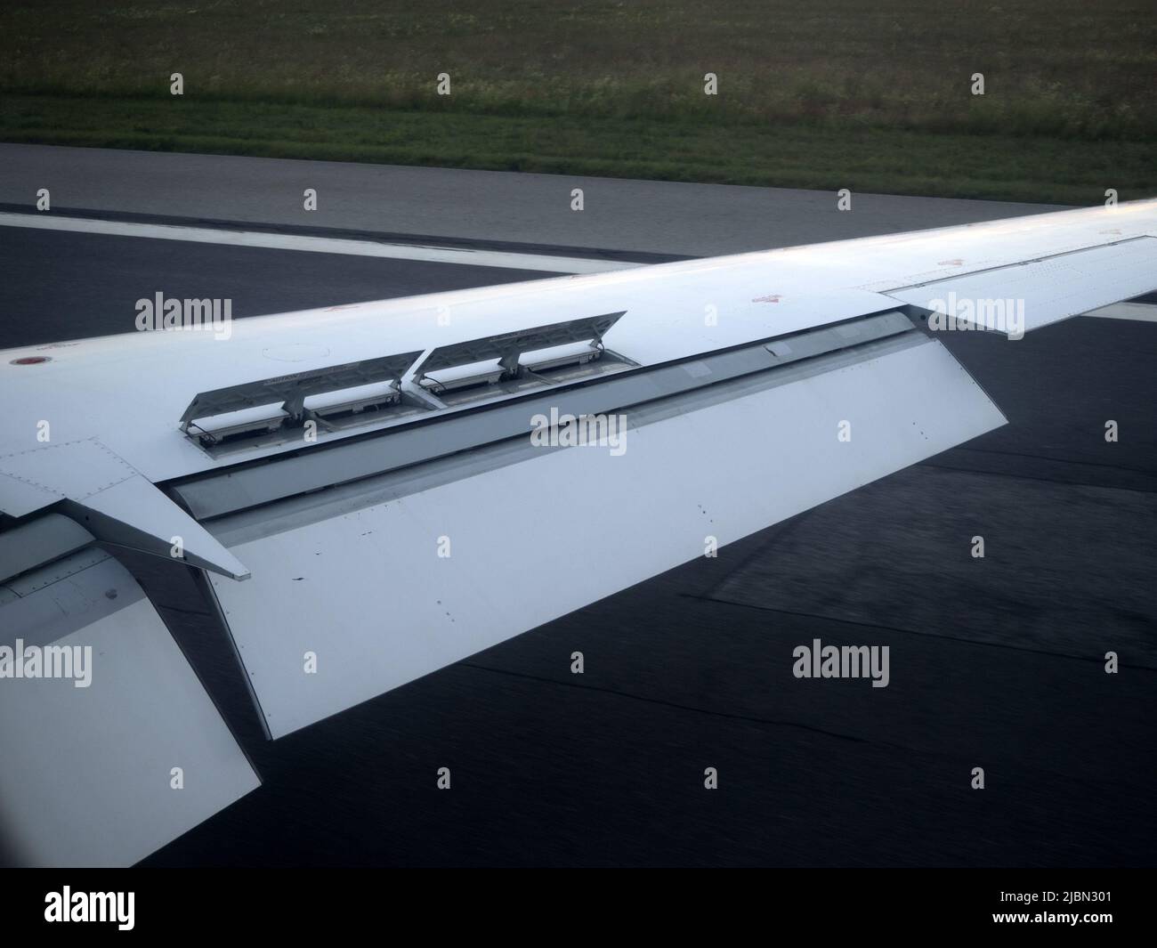 Airplane open flaps while landing detail Stock Photo - Alamy