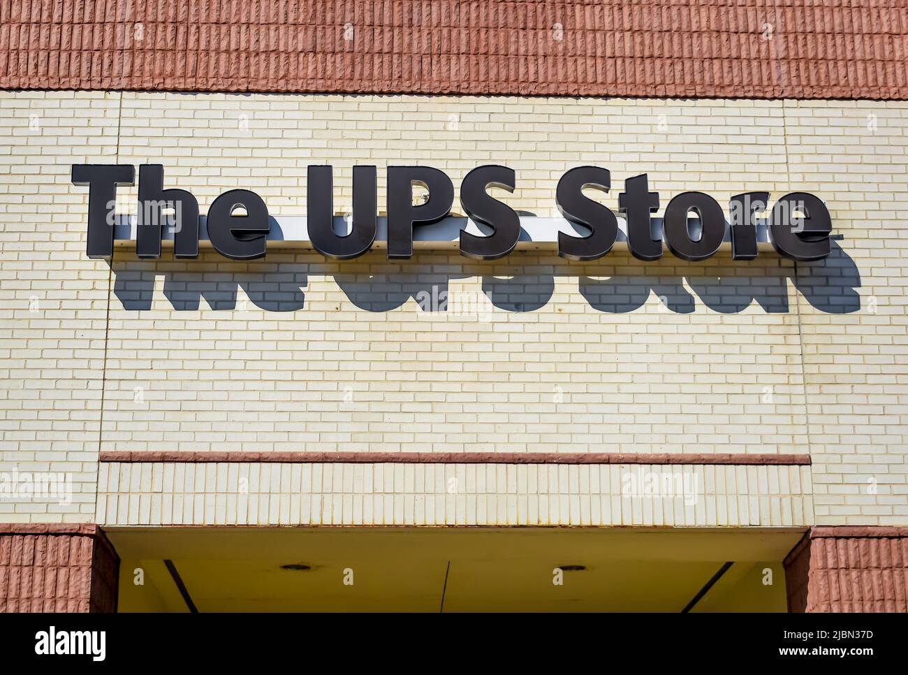The UPS Store's exterior facade brand and logo signage in black letters ...