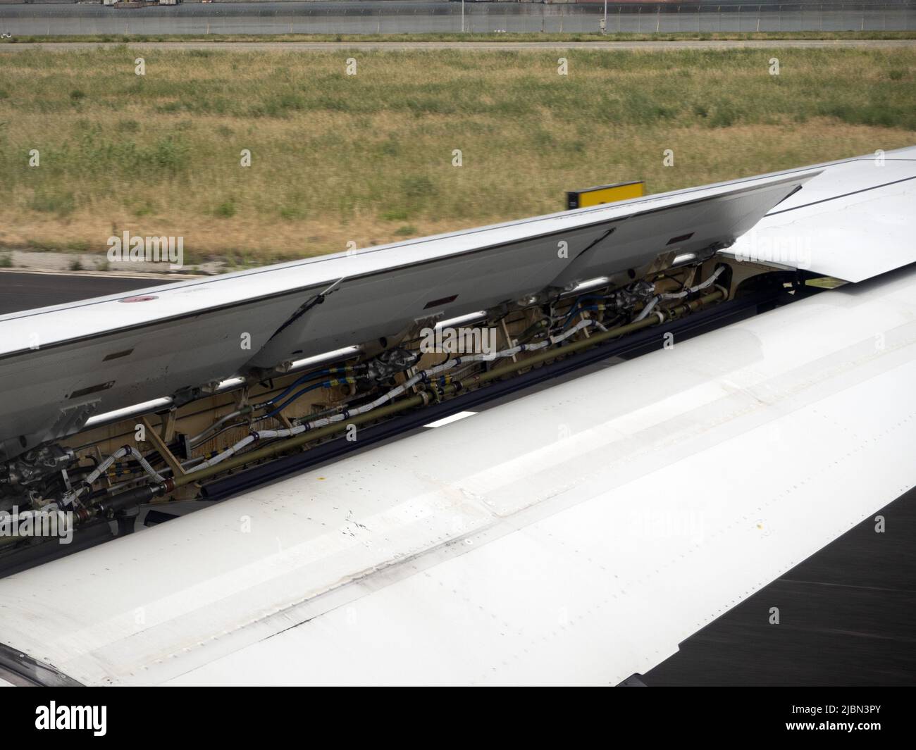 Airplane open flaps while landing detail Stock Photo - Alamy