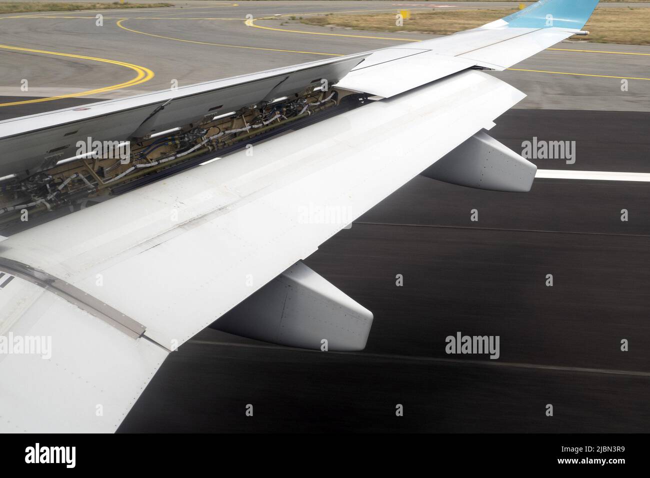 Airplane open flaps while landing detail Stock Photo - Alamy