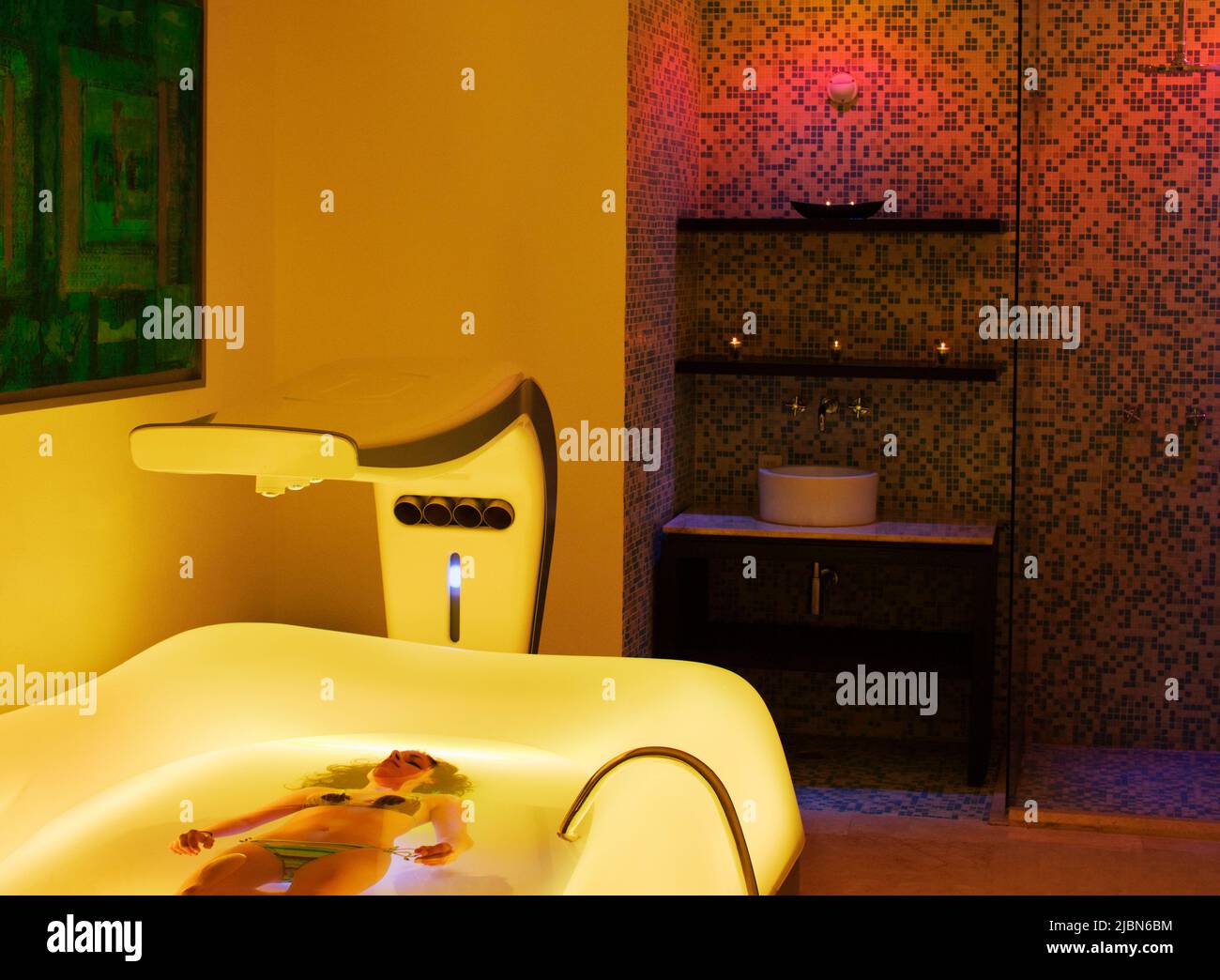 A woman floats in a chromotherapy tub during the Dream State treatment ...