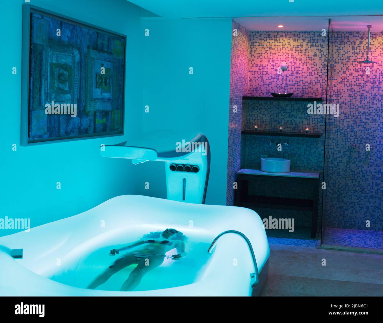 A woman floats in a chromotherapy tub during the Dream State treatment ...