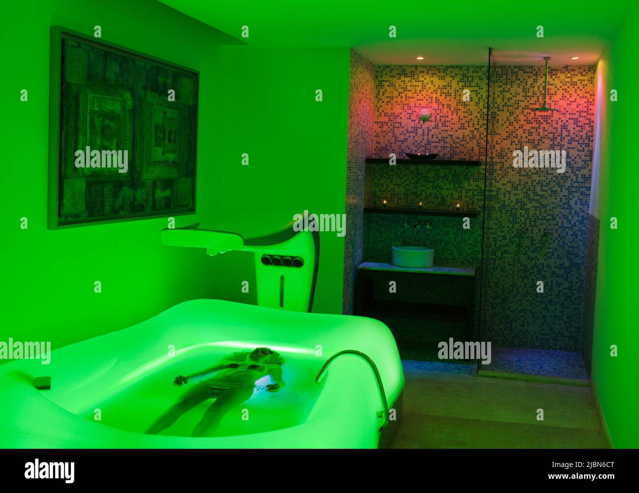 A woman floats in a chromotherapy tub during the Dream State treatment ...